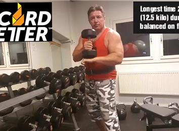 Longest Time Balancing A 27.5-Pound Dumbbell On Fist | World Record ...